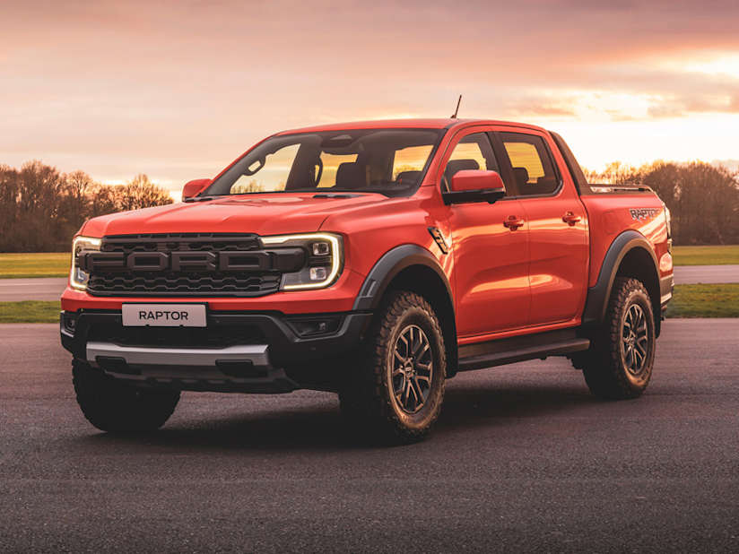 Orange Ford Raptor Lifted